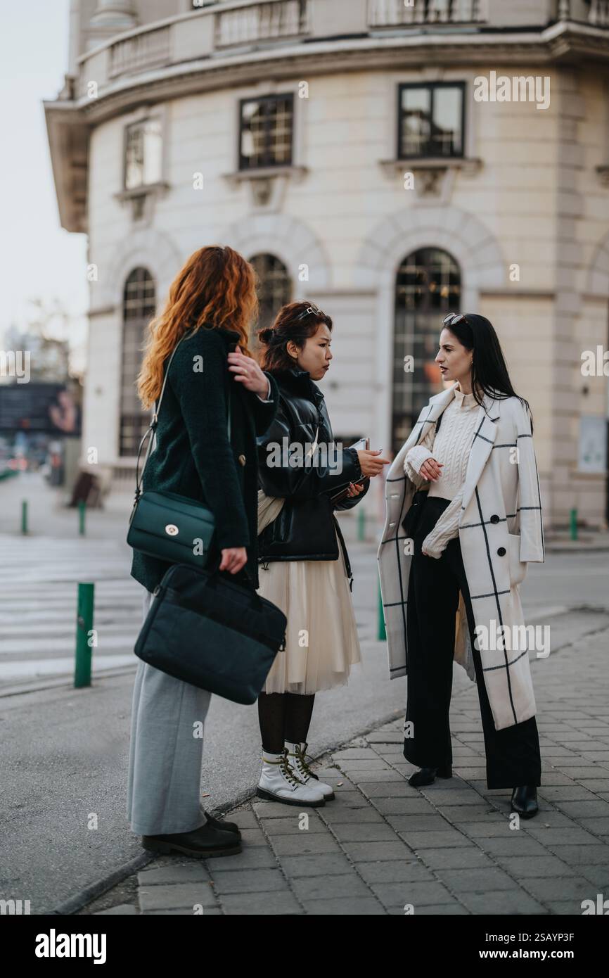 Three stylish women in conversation outside a classical building Stock ...