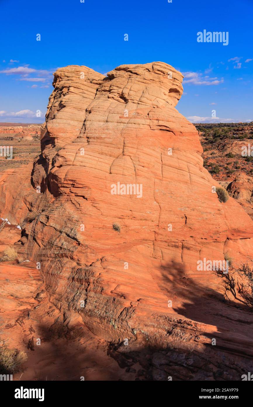 A large rock formation with a shadow on it. The shadow is on the right ...