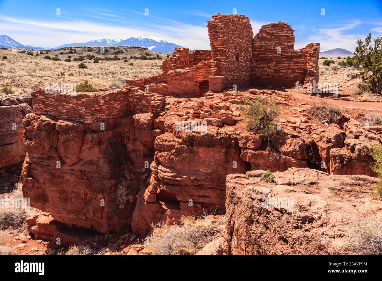 A rocky desert landscape with a large building in the distance. The ...