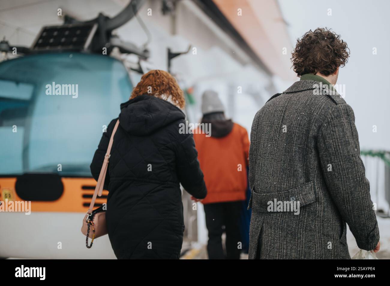 People boarding a ski lift during winter in a snowy setting Stock Photo ...