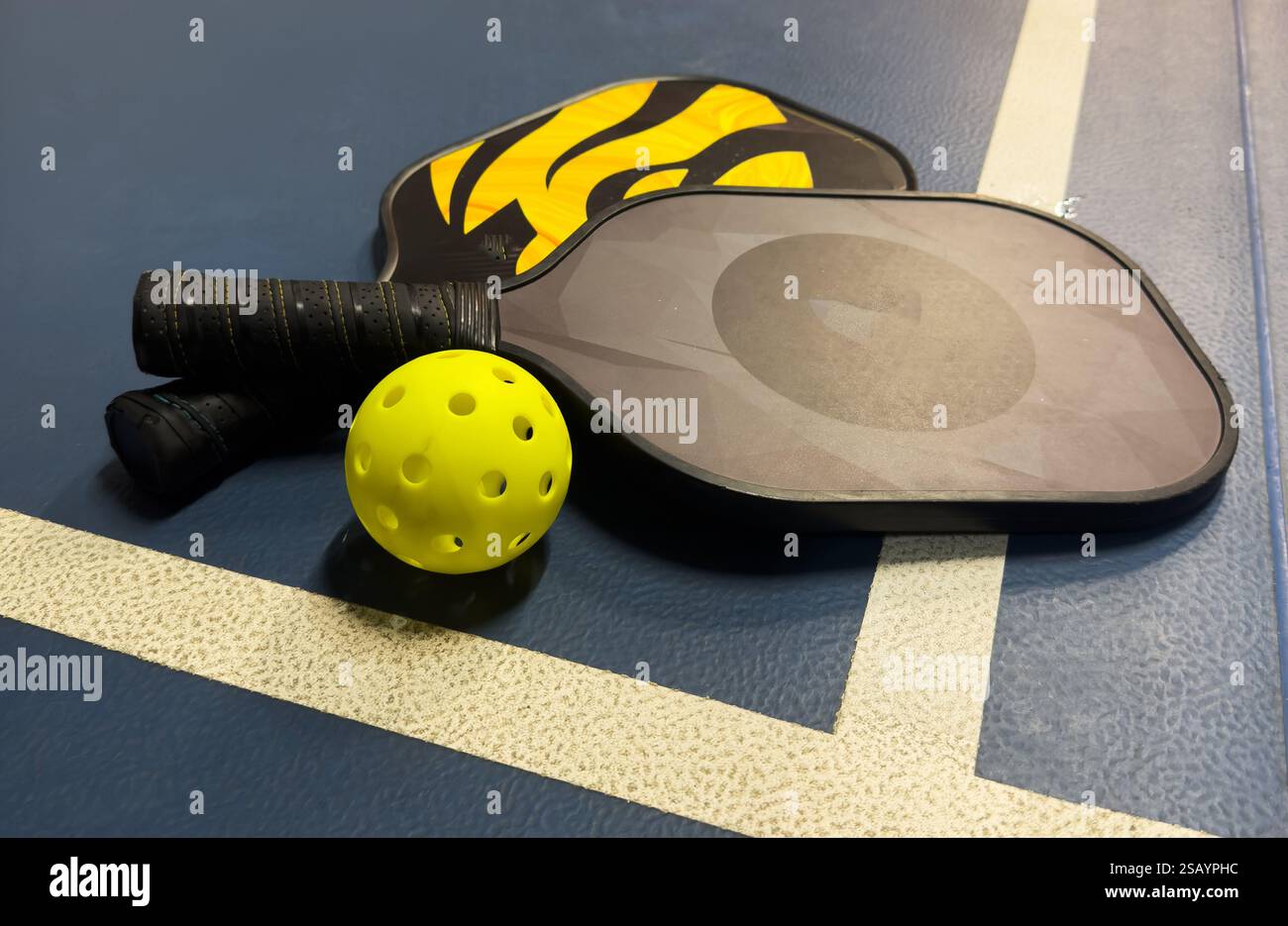 Pickleball tennis racket on the court. Blue background with copy space ...