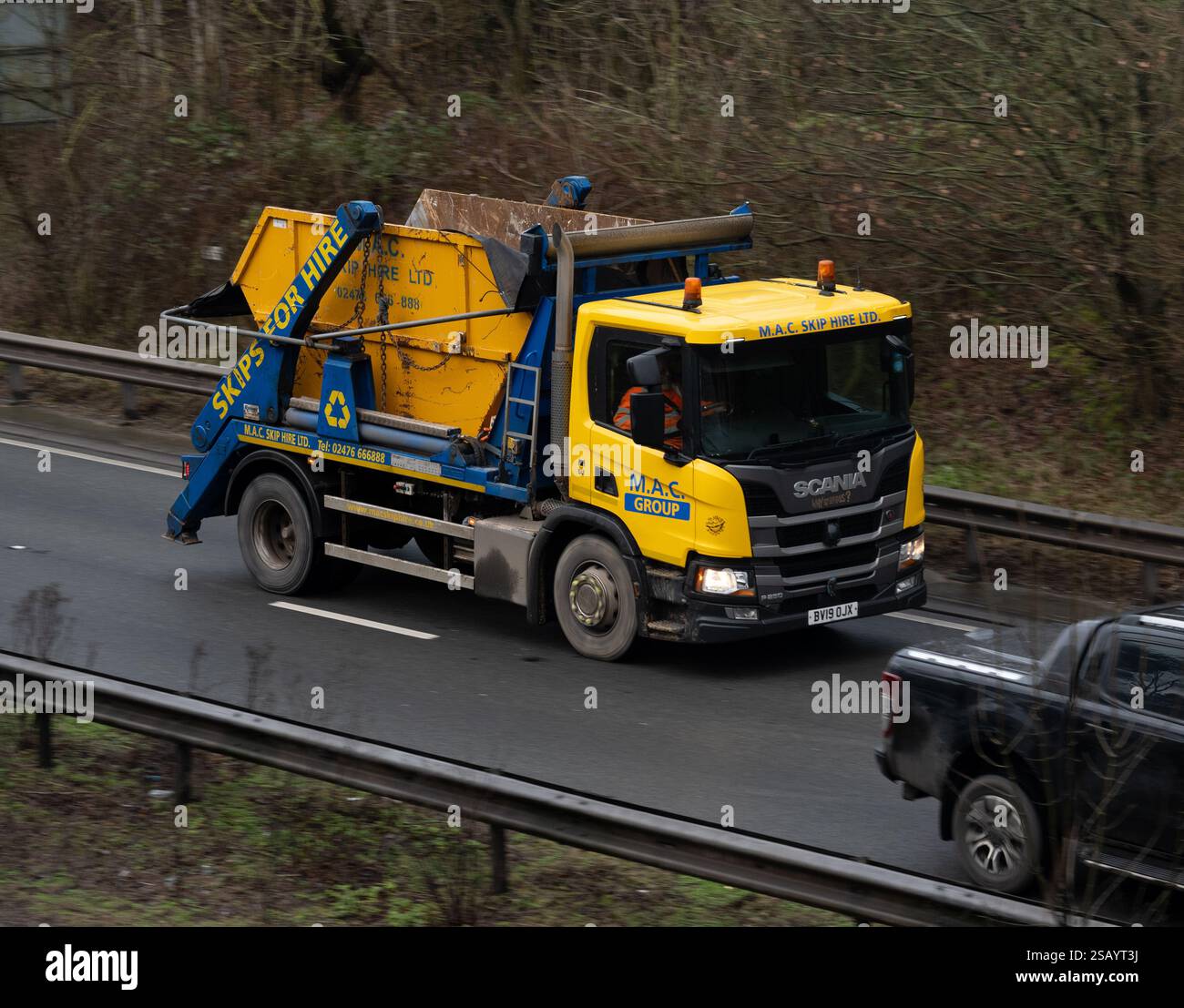 Skip lorry on road hi-res stock photography and images - Alamy