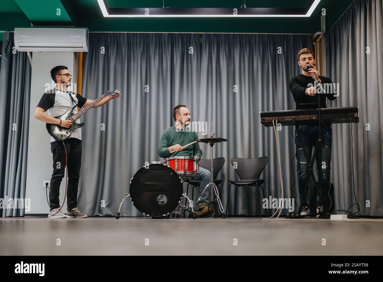 Talented musicians rehearsing in a modern studio for an upcoming ...