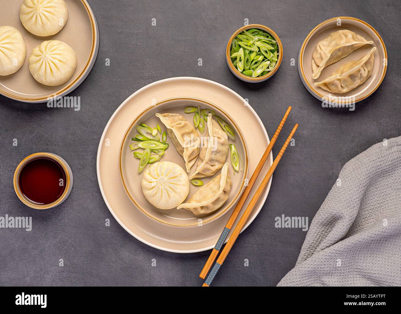 Food photography of steamed duck bao buns and chicken gyoza, spring ...
