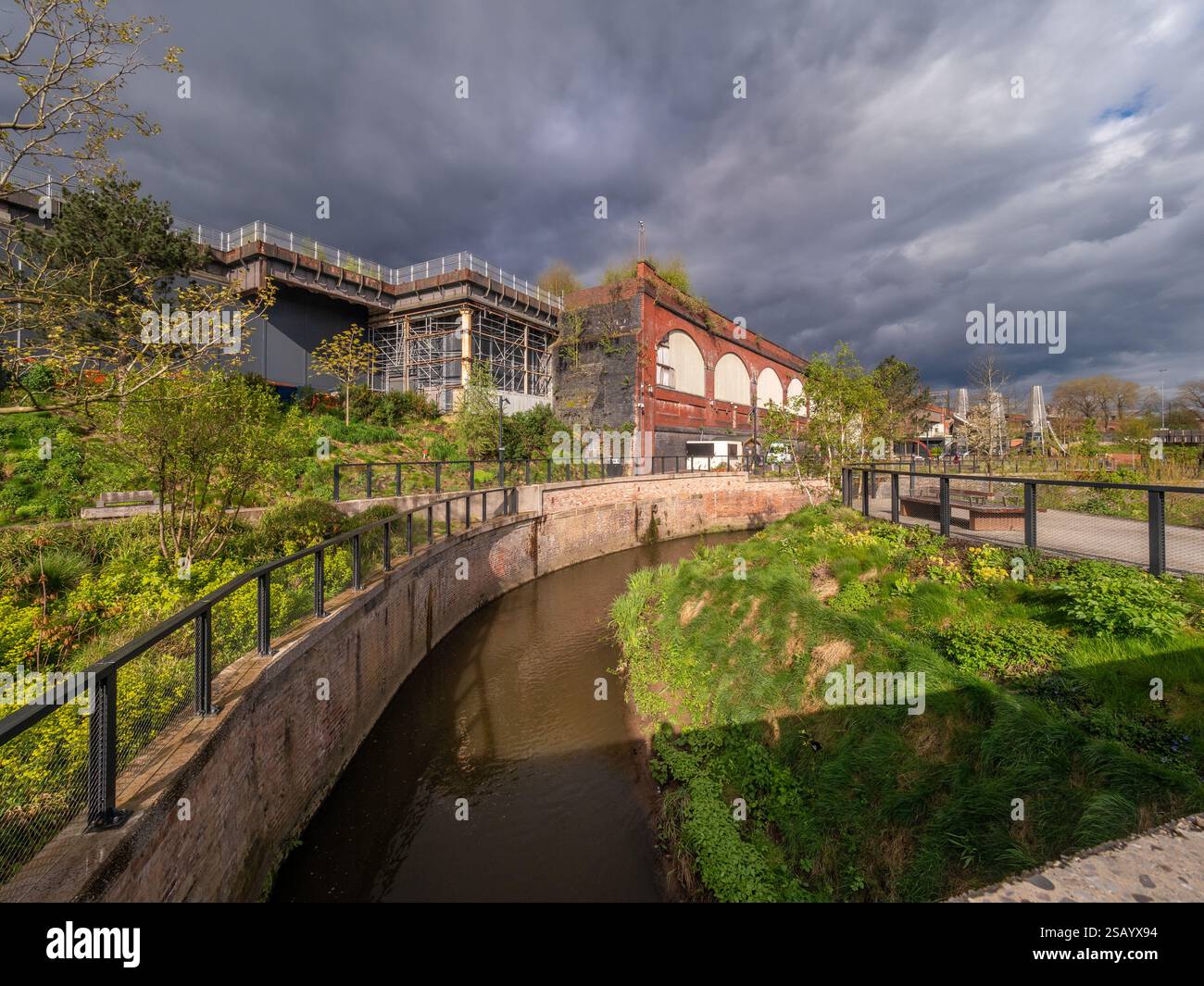 River Medlock flowing through Mayfield Park with Depot Mayfield on the ...