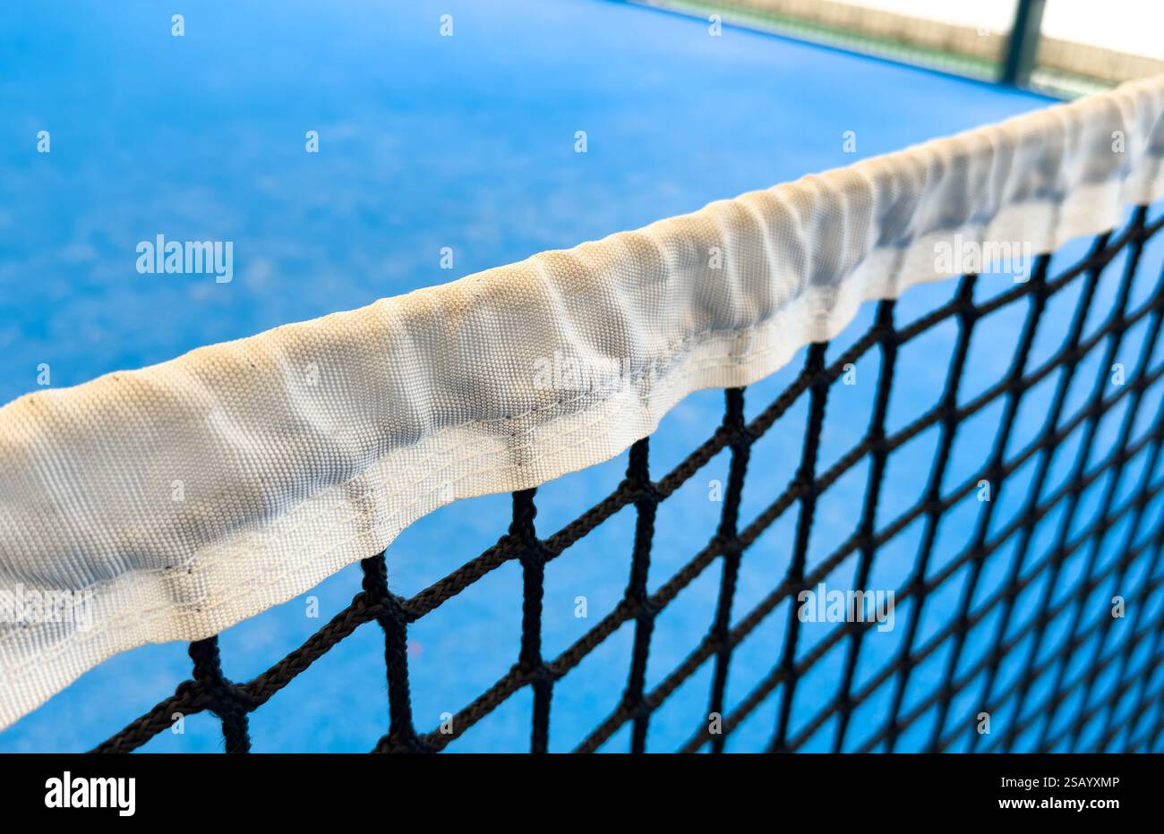 Outdoor padel Court with Tennis Net. Active game on blue court with ...