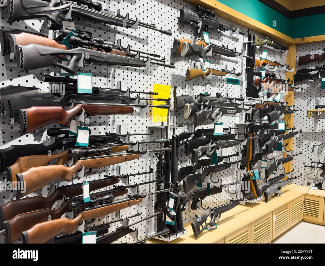 Gun shop interior with various handguns displayed on wall rack Stock Photo - Alamy