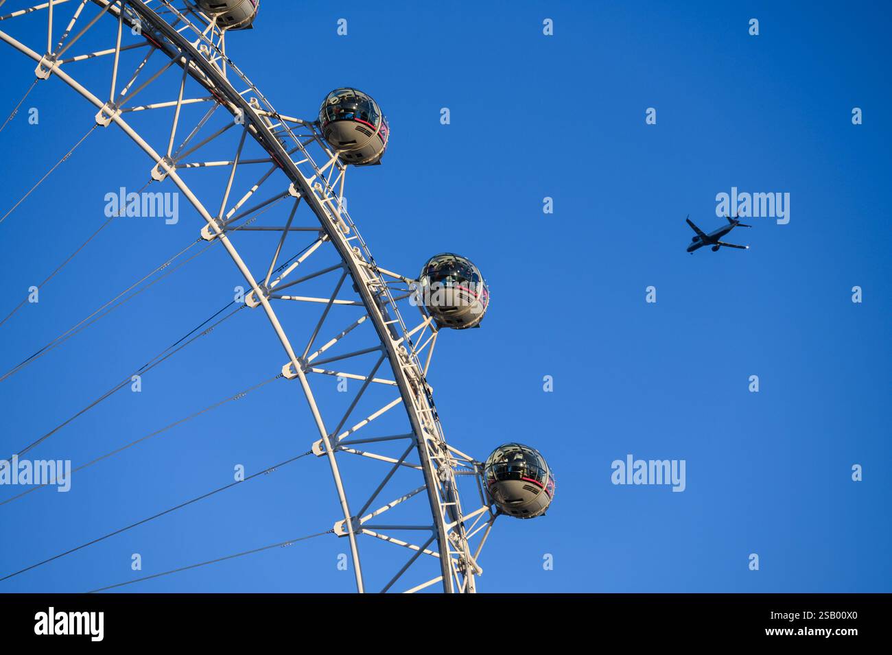 London, UK. Airplane flying above the London Eye Stock Photo - Alamy