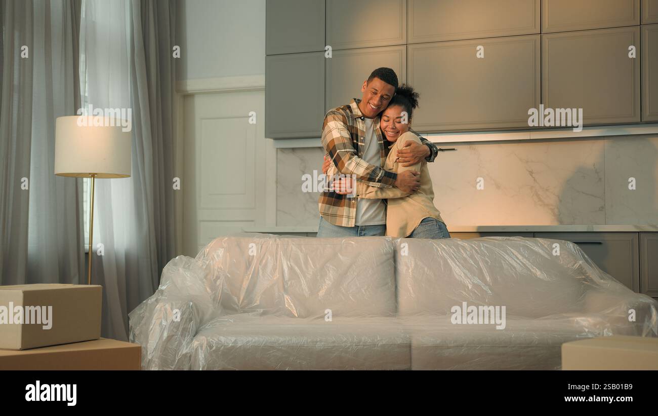 Happy male female home owners African American family moving in new ...