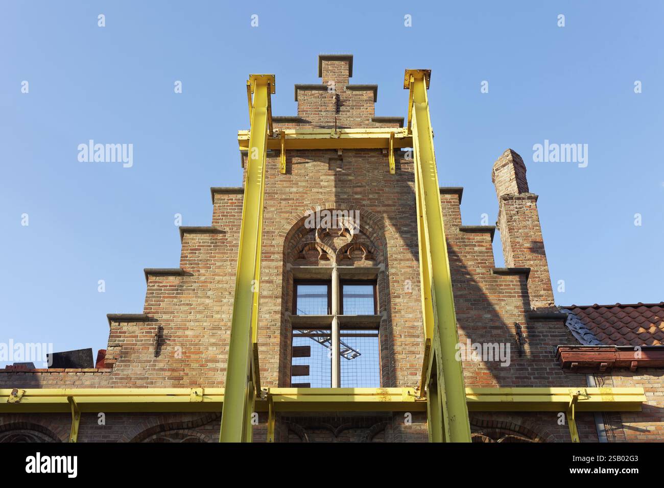Steel girders support staircase gable of a historic house facade, gutting, construction site ...