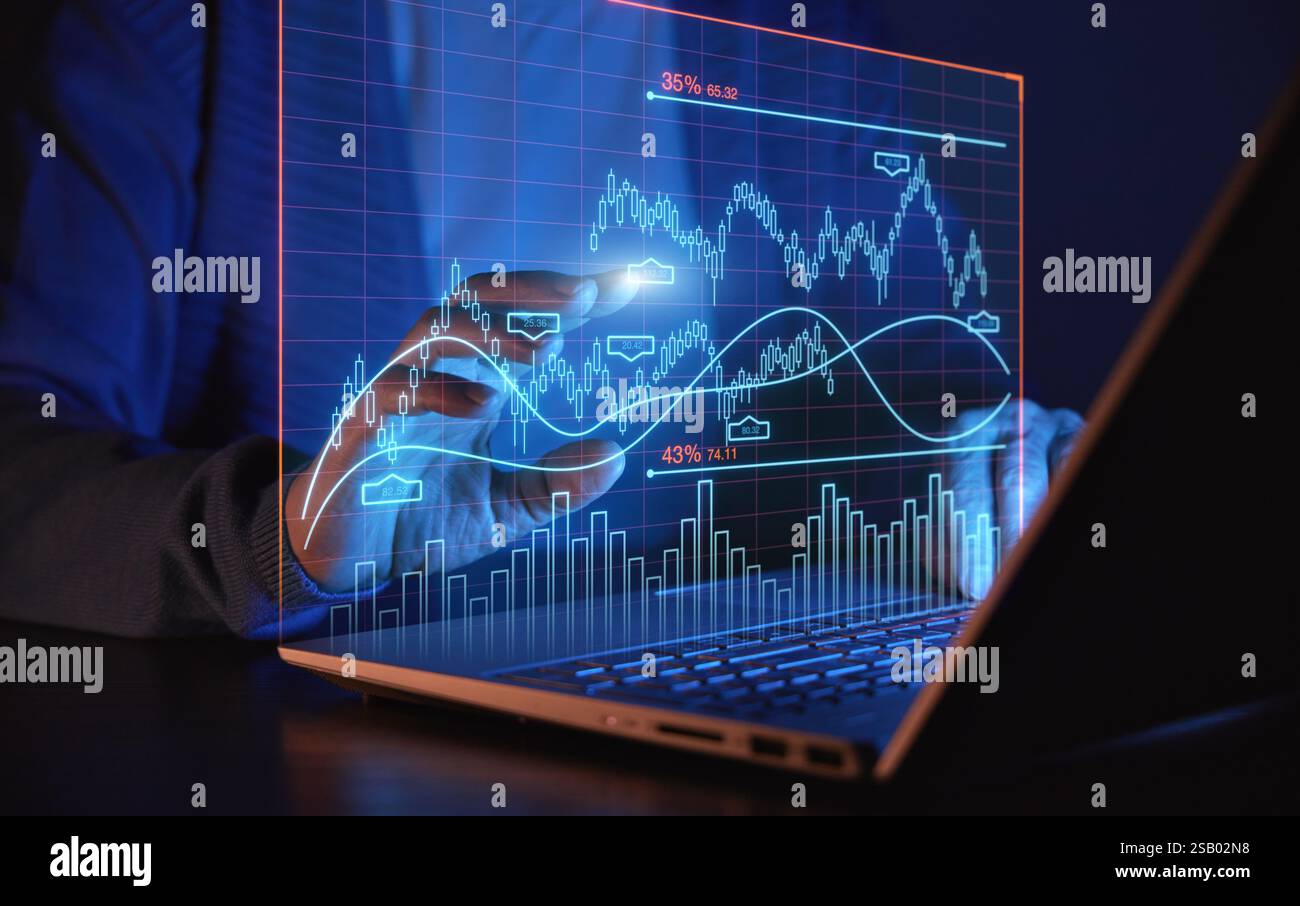 A person is analyzing graphs on a laptop, using virtual elements for ...