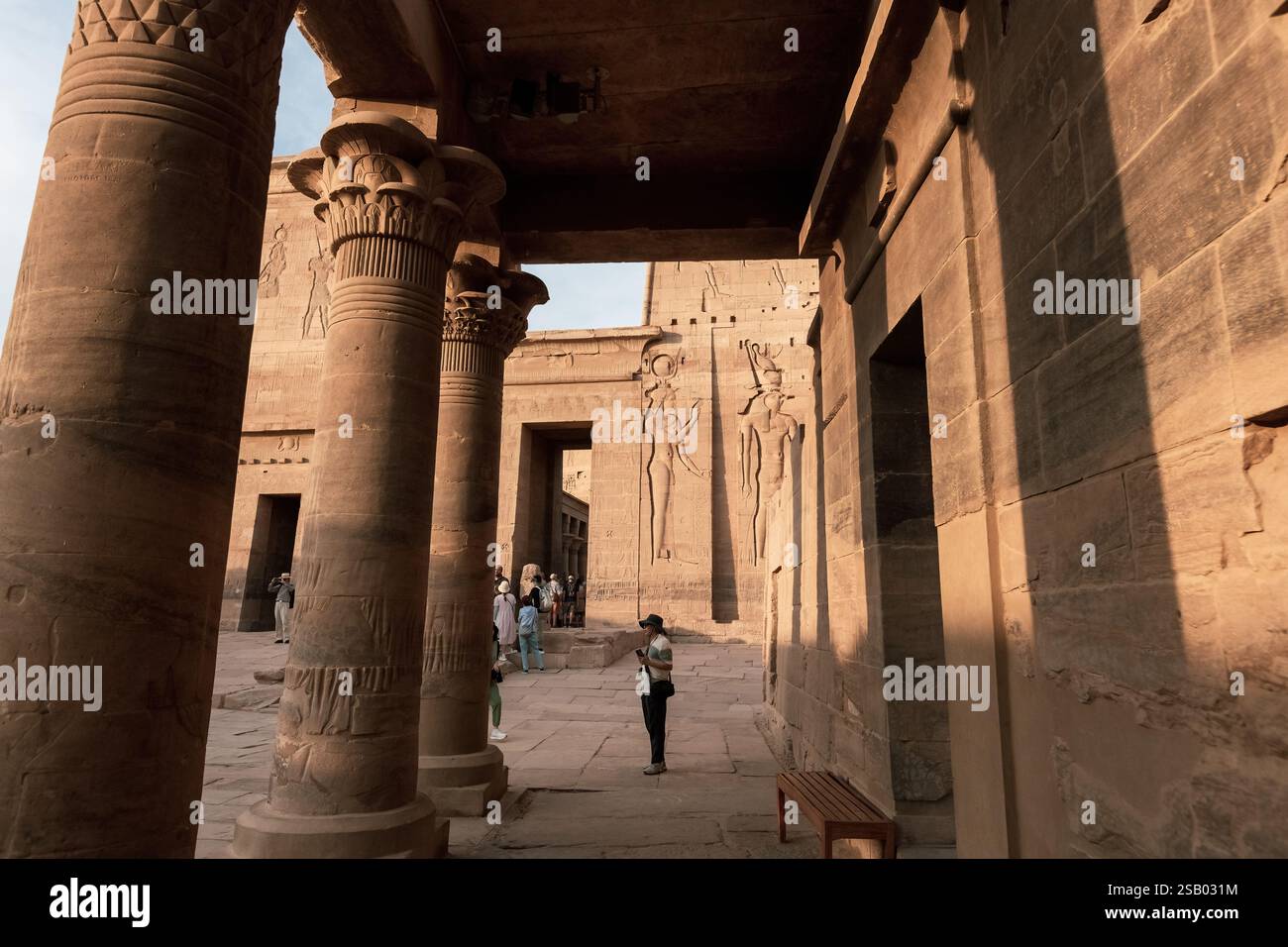 Details of Philae temple in Aswan Upper Egypt. Stone carved pillars with Egyptian god images ...