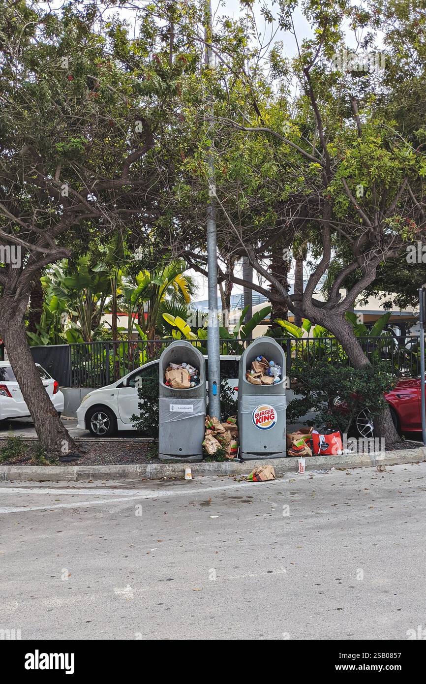Overfilled fast-food Burger King trash bins with litter in public ...