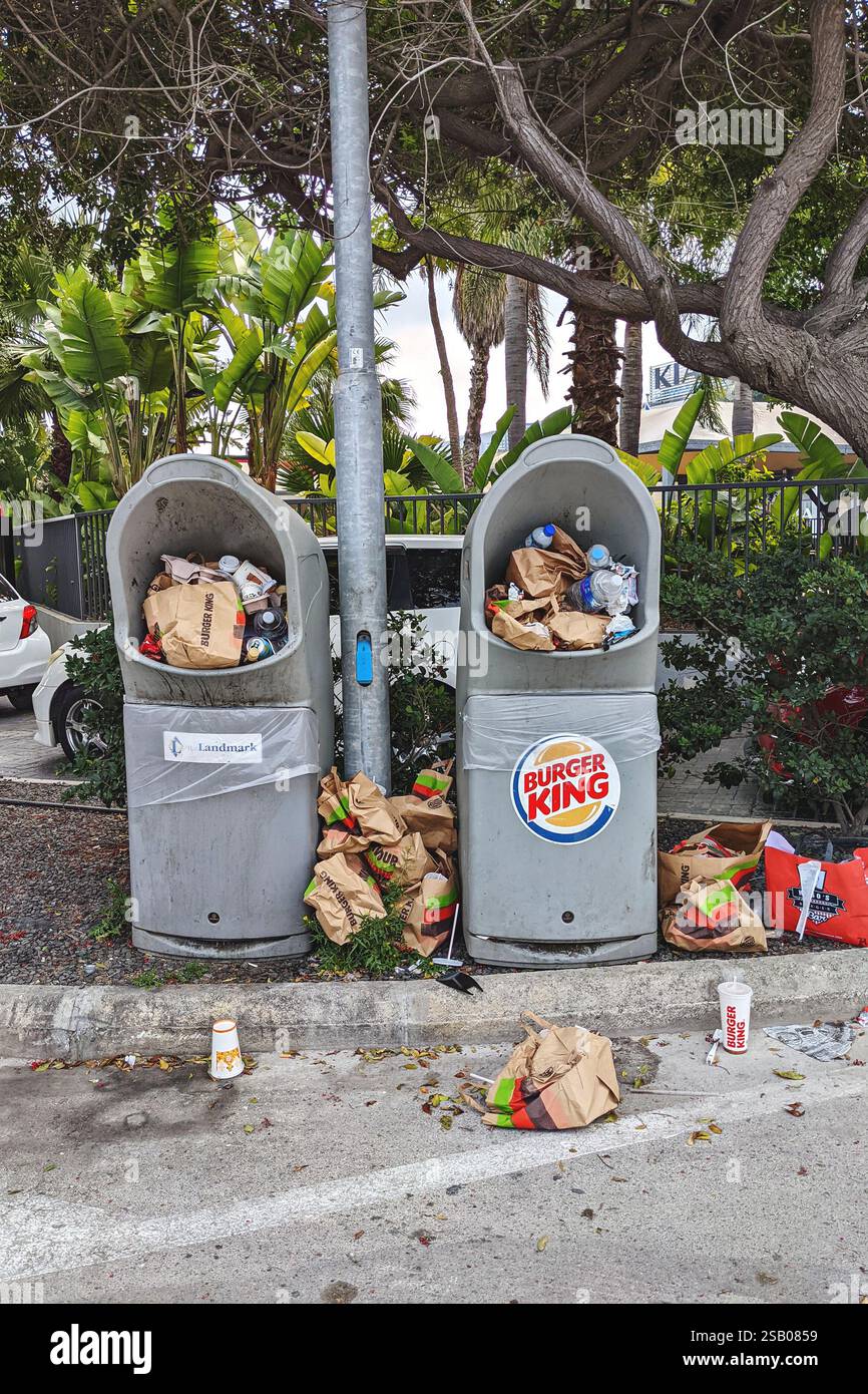 Overfilled fast-food Burger King trash bins with litter in public ...