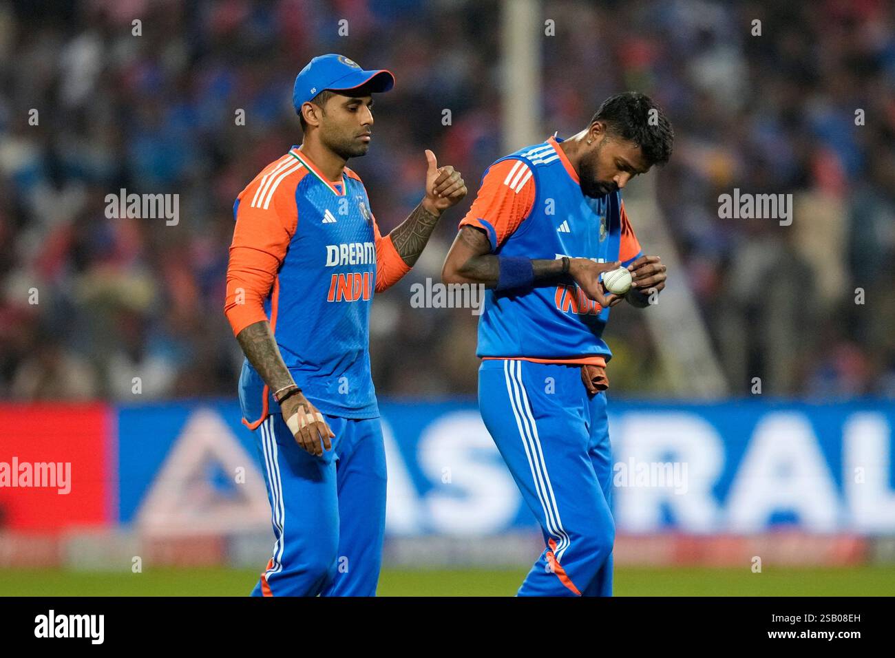 India's captain Suryakumar Yadav, left, talks to teammate Hardik Pandya as the latter prepares ...