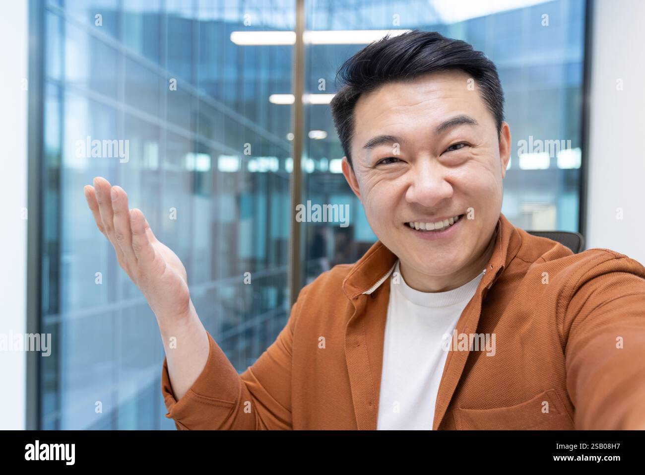 Happy and successful Asian man talking using video call app on phone ...