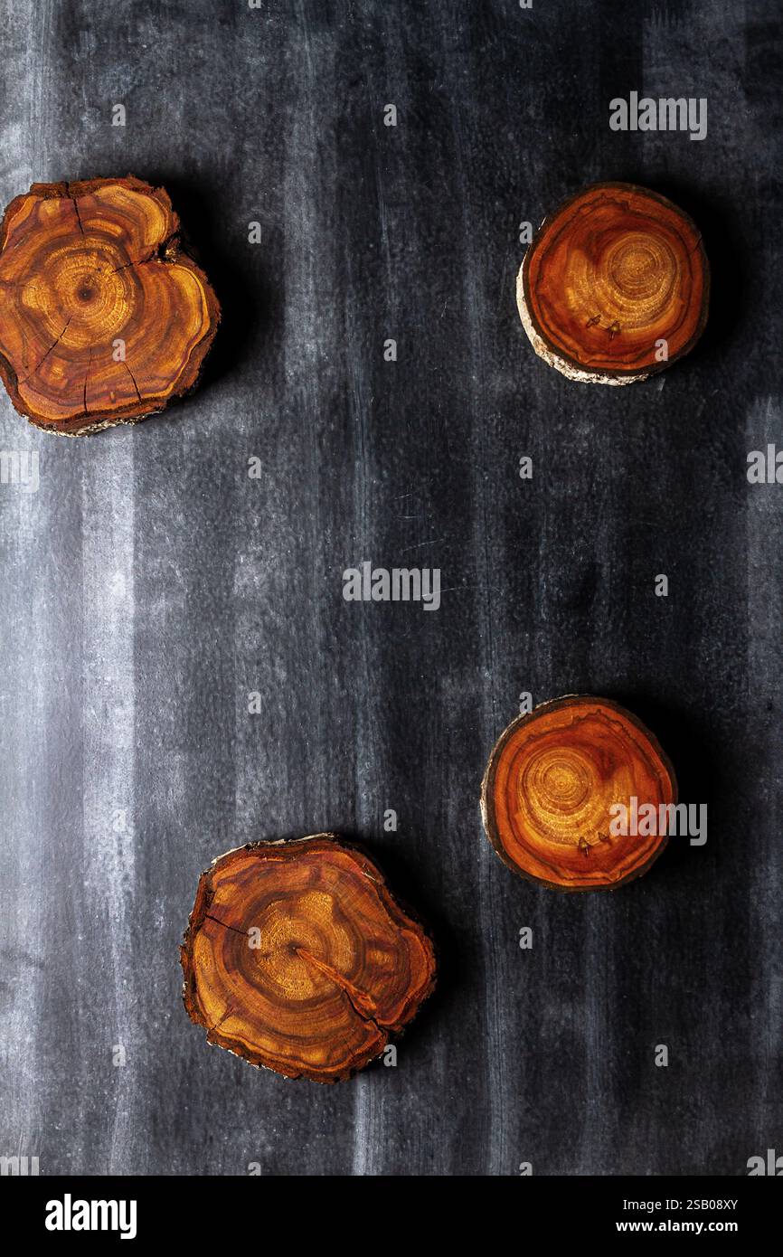 Wood log tree slices on black chalkboard. Flat lay. Top view Stock ...