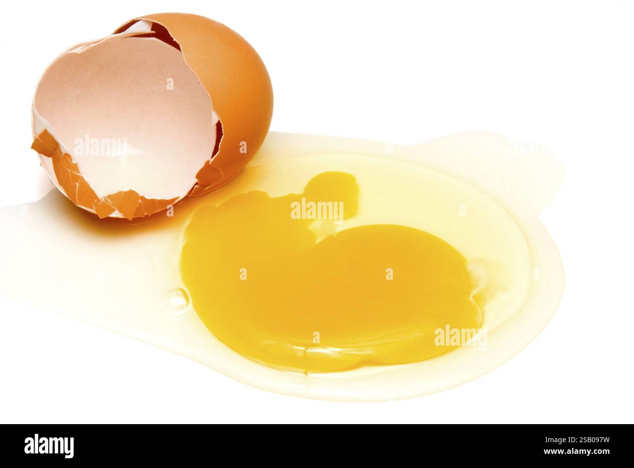 A brown egg broken open and ready to be cooked Stock Photo - Alamy