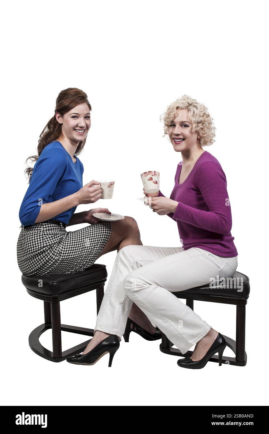 Beautiful women having a social tea party Stock Photo - Alamy