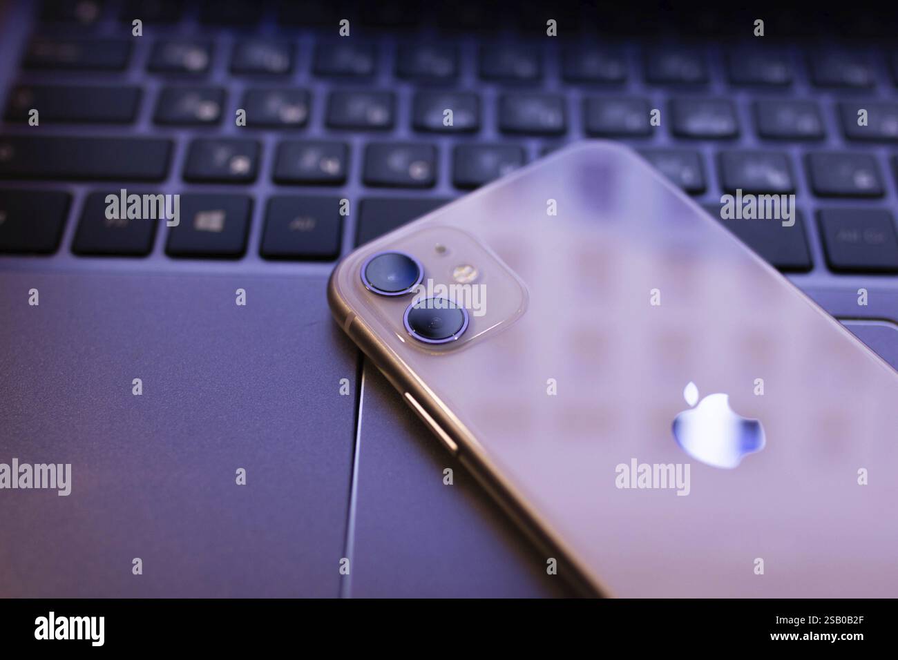 Smartphone placed on a keyboard, showing reflections and focusing on ...