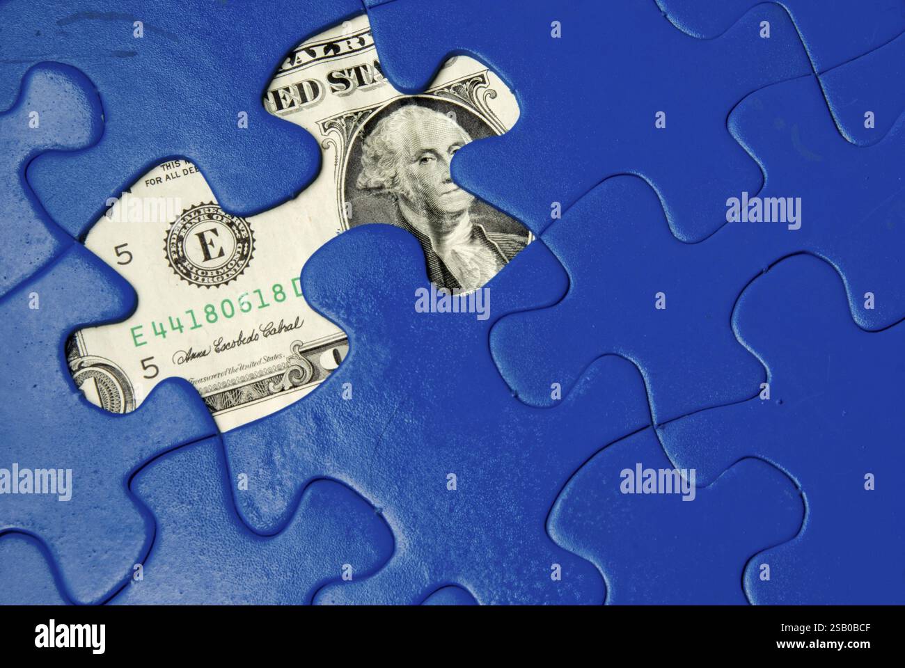 A puzzle covering up a one dollar bill Stock Photo - Alamy