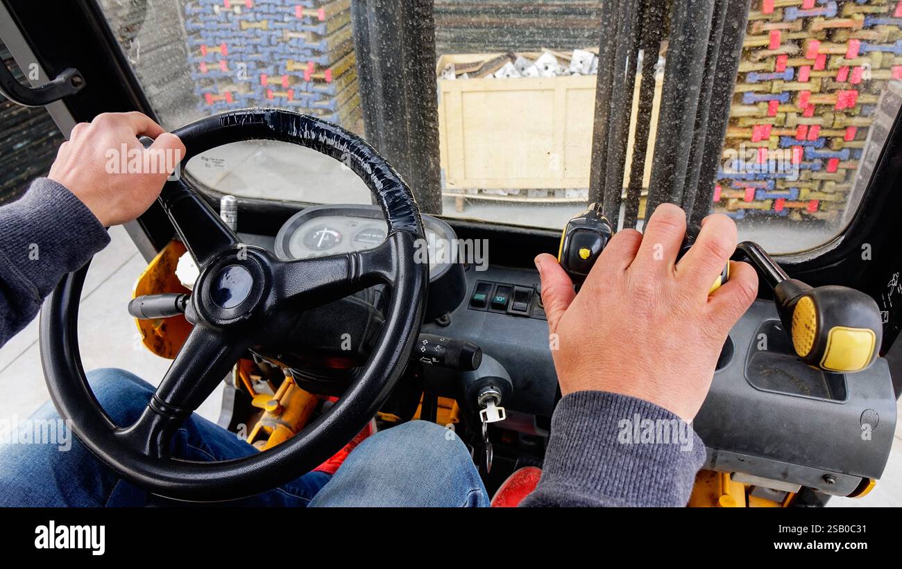 forklift operator uses forklift Stock Photo - Alamy