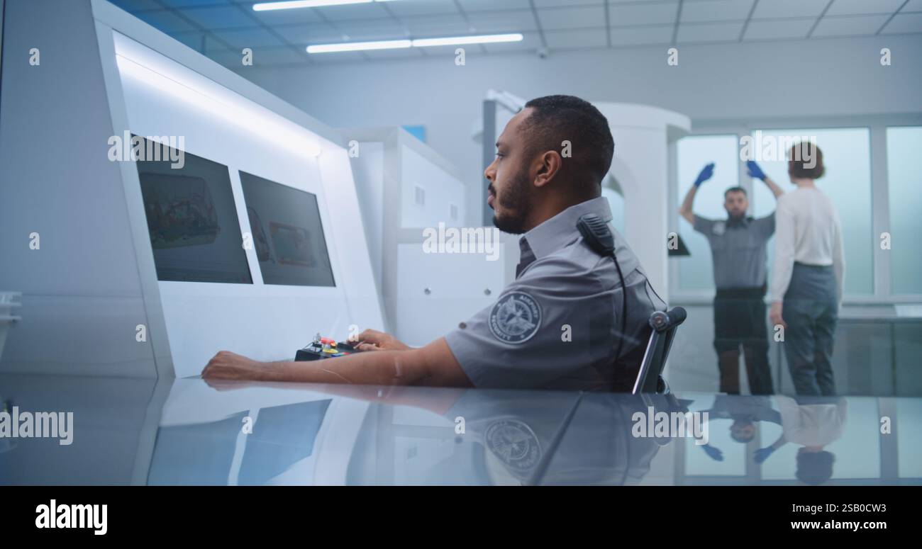 Airport: African American Security Officer Monitors Baggage Screening ...