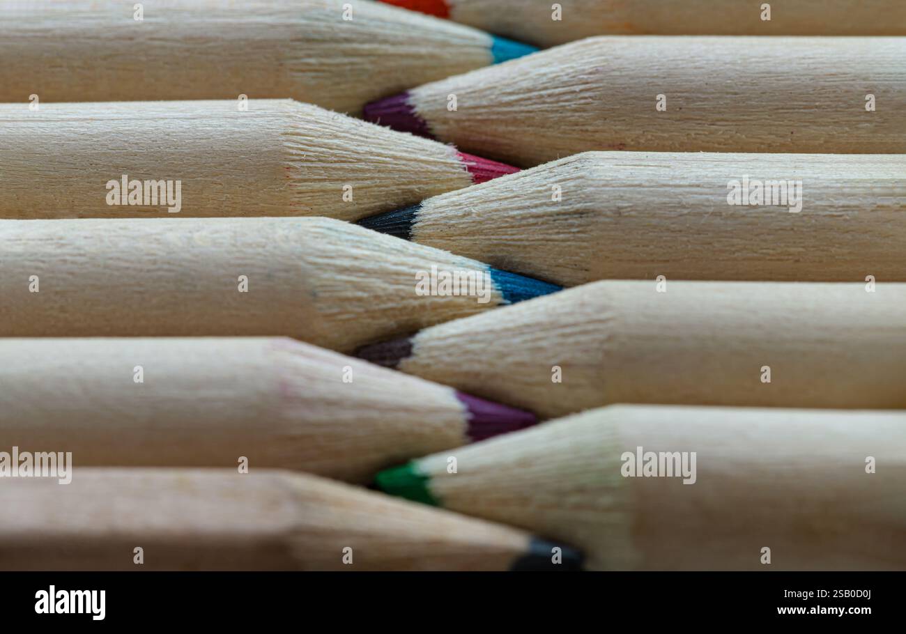 Close-up of Two groups brown crayons are sharp tips and facing collide ...