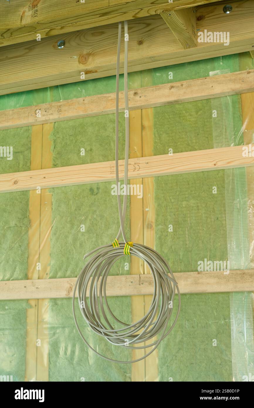 The first fix by electricians in wiring a property. Coiled wire ready for installation. Vapour ...