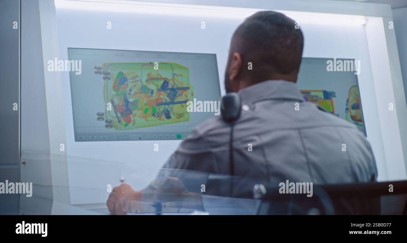 Back View of African American Security Officer Controlling Luggage ...