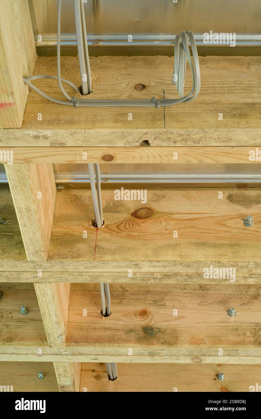 Underfloor heating pipes and new electrical wires through ceiling joists. First fix in a new ...