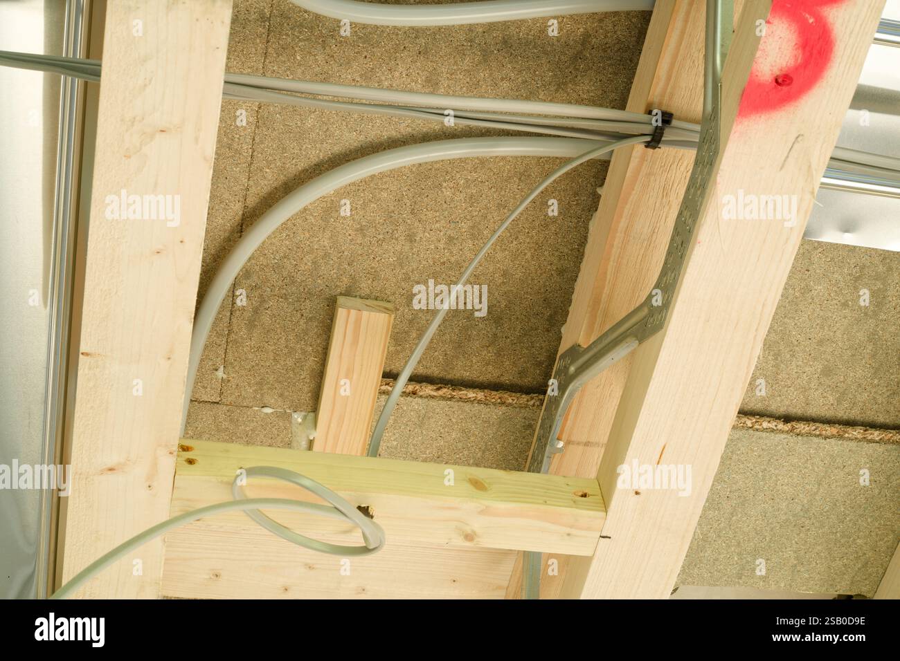 Underfloor heating pipes and new electrical wires through ceiling joists. First fix in a new ...