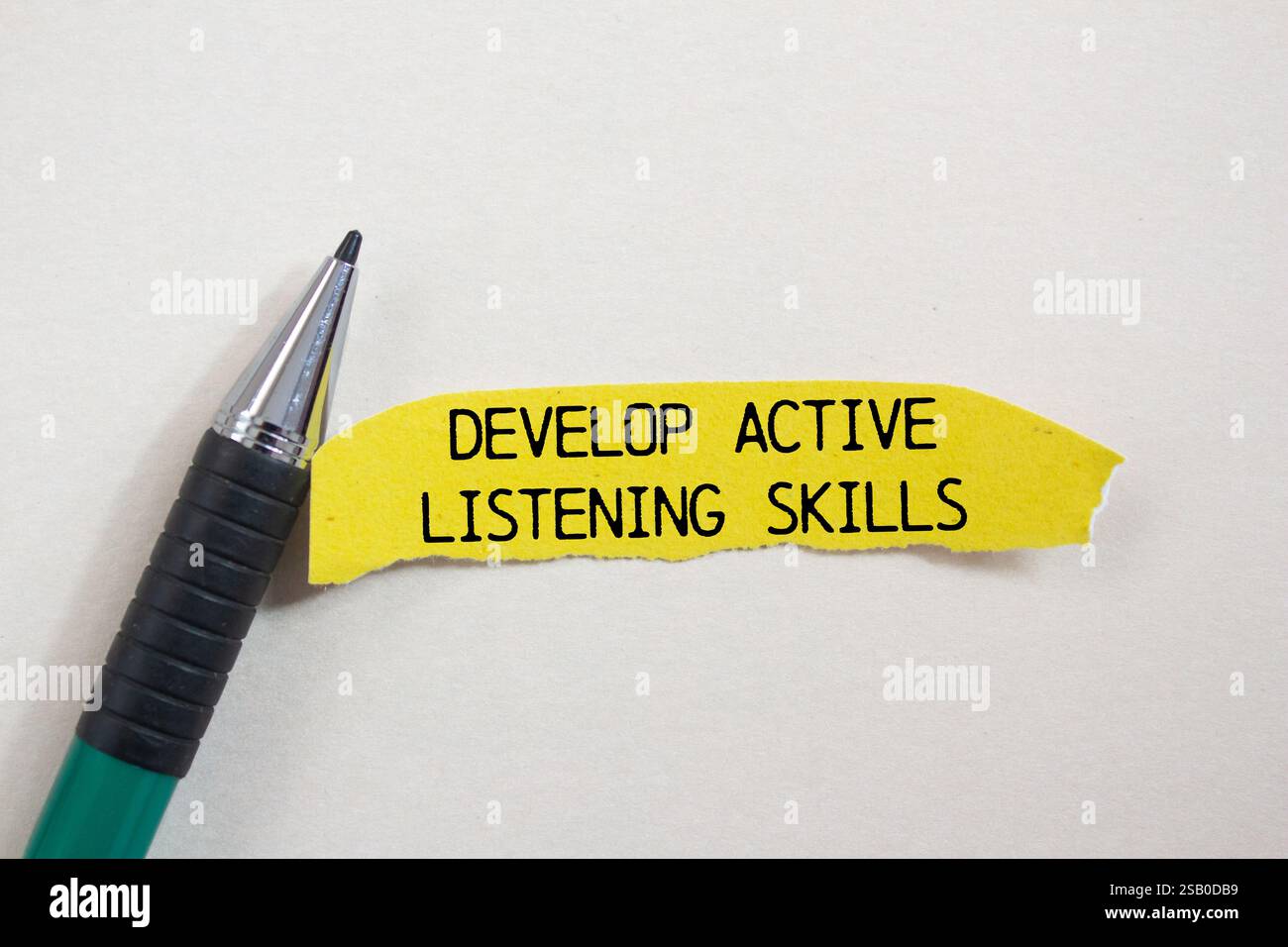 Develop active listening skills message written on ripped torn yellow ...