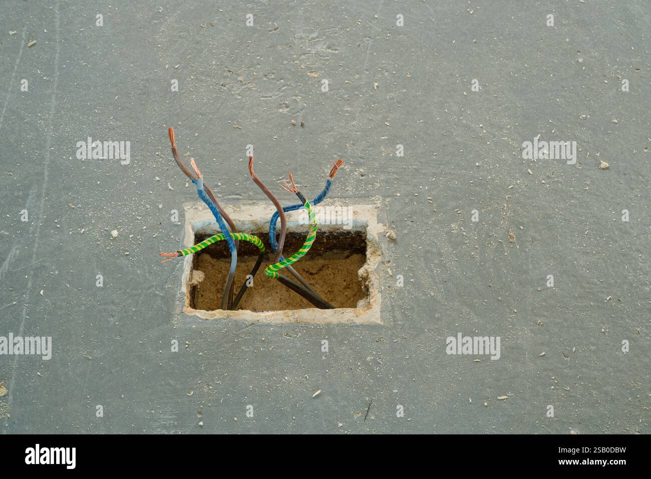 Electrical wiring in a concrete floor for a socket Stock Photo - Alamy