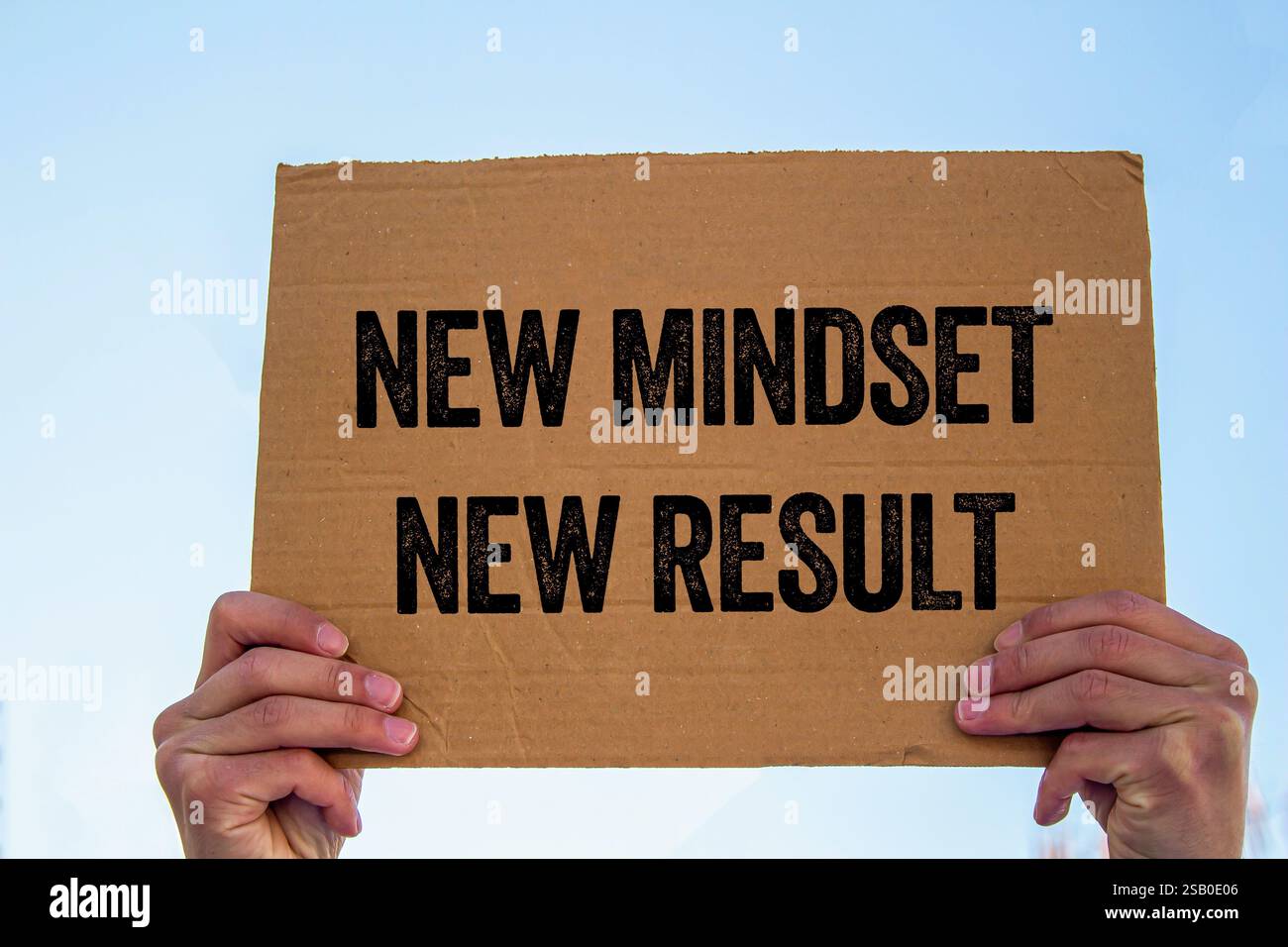New mindset new result message written on cardboard sign. Conceptual ...