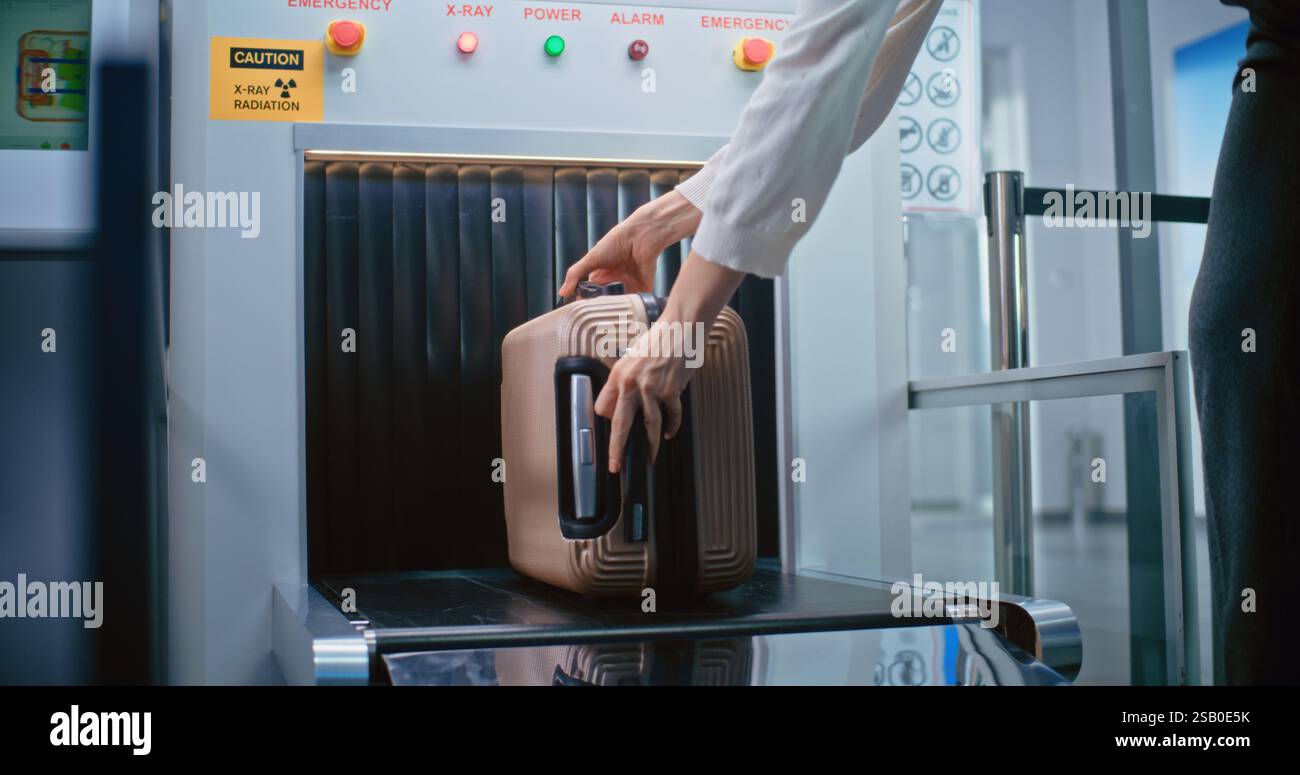 Security Checkpoint in Airport Terminal: Passenger Places Suitcase on ...