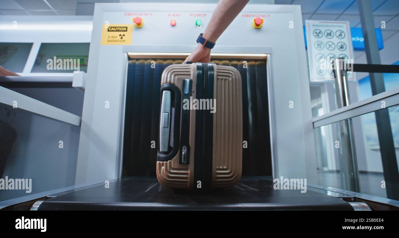 Security Check in Airport Terminal: Passenger Places Suitcase on Conveyor Belt for Baggage ...