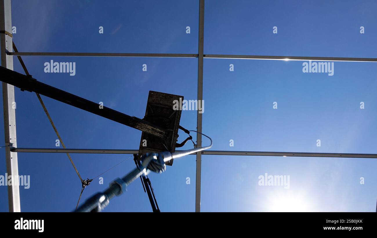 Man workers on a crane performs high-rise work on welding metal ...