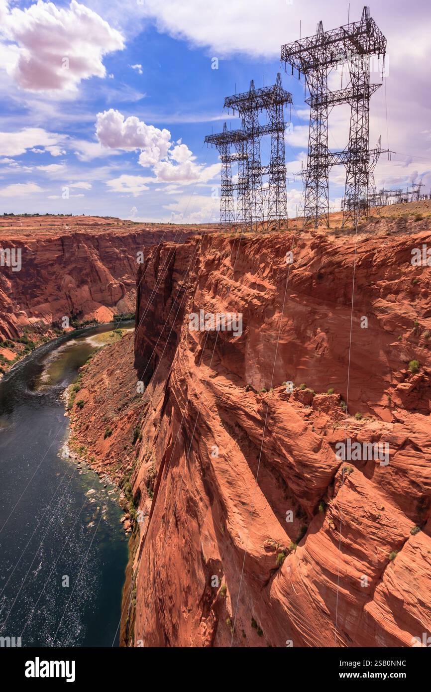 A river runs through a canyon with a few power lines in the background ...