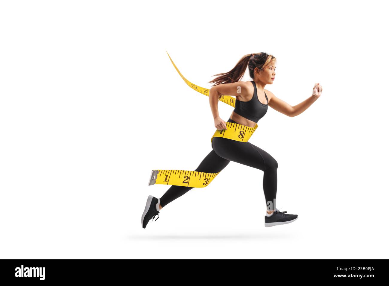 Full length profile shot of a young asian woman running with measure ...