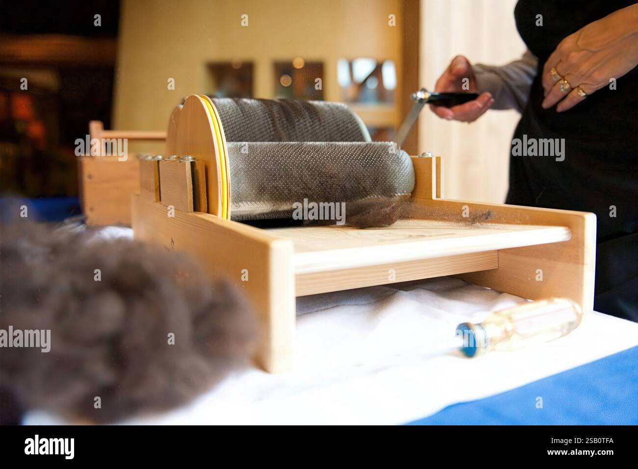 Carding machine in operation, illustrating the process of wool ...