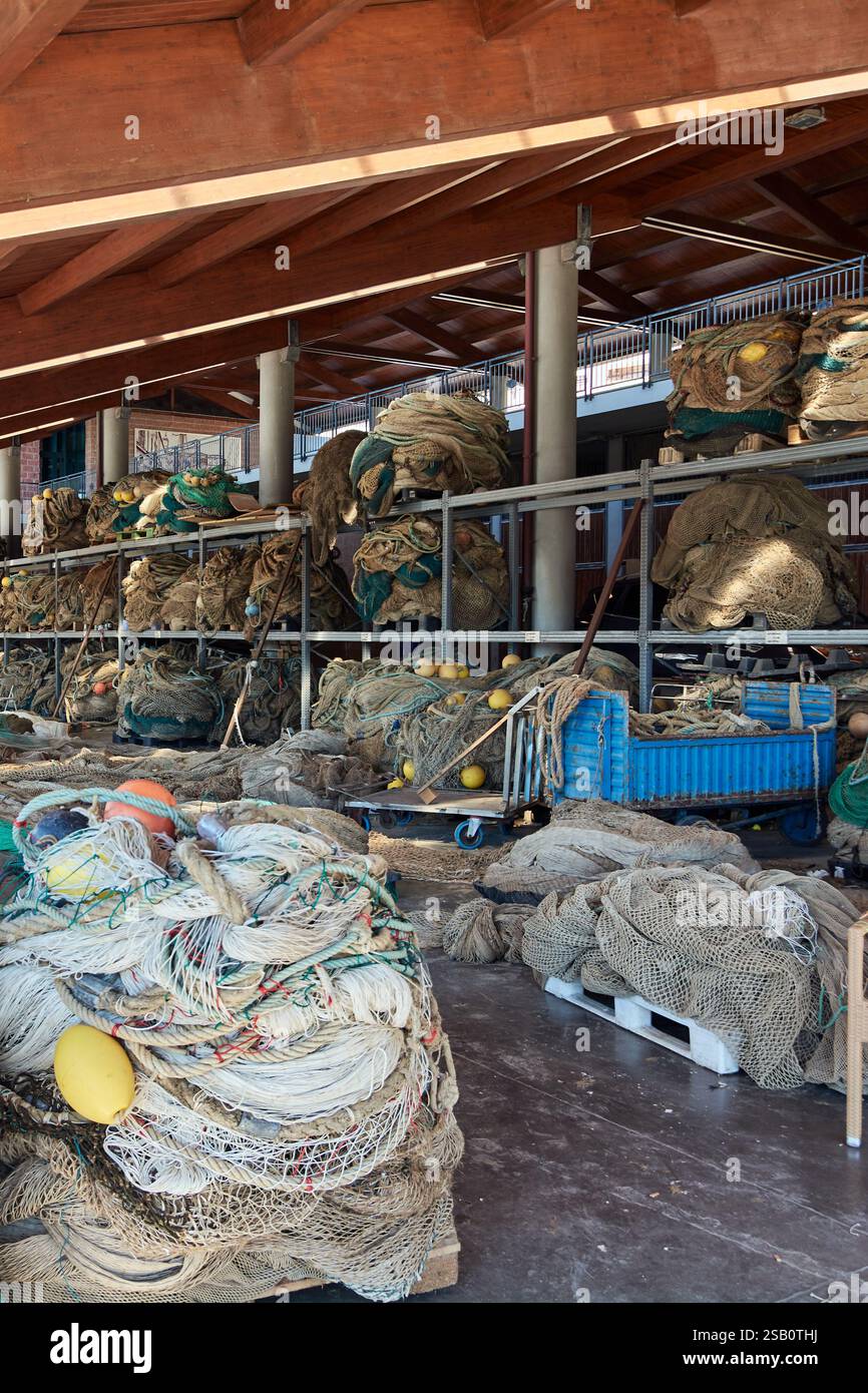 A portside fishing net repair area filled with commercial fishing gear ...