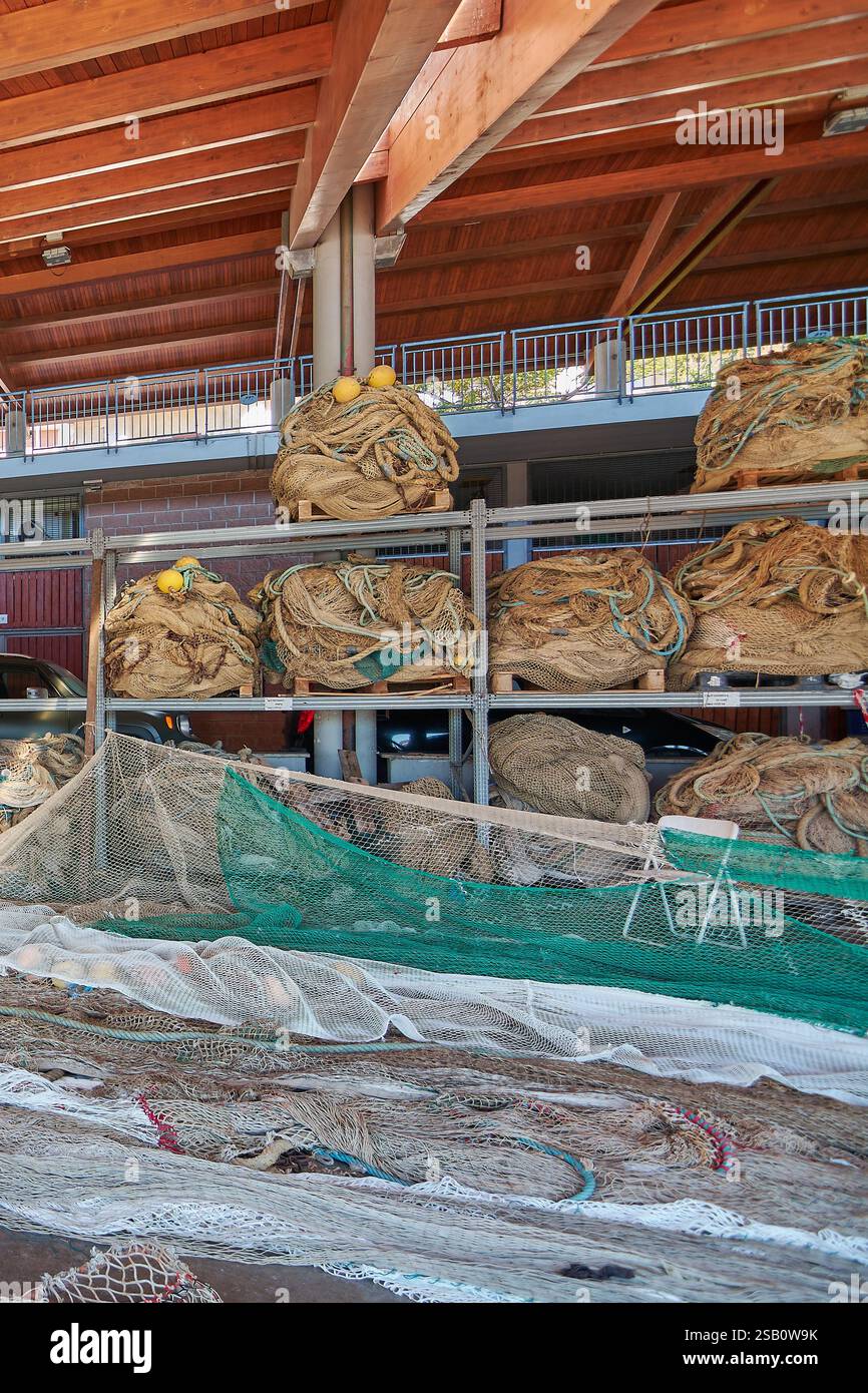 A fishing net repair station in a spacious maritime facility. Large ...