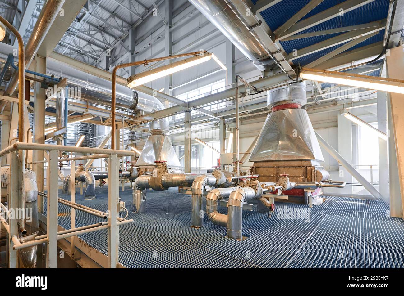 Inside a modern chemical plant featuring extensive pipelines and ...