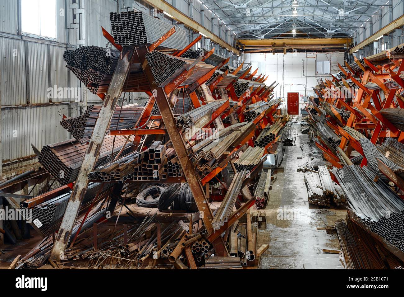 Rolled metal products on large racks in cold storehouse Stock Photo - Alamy