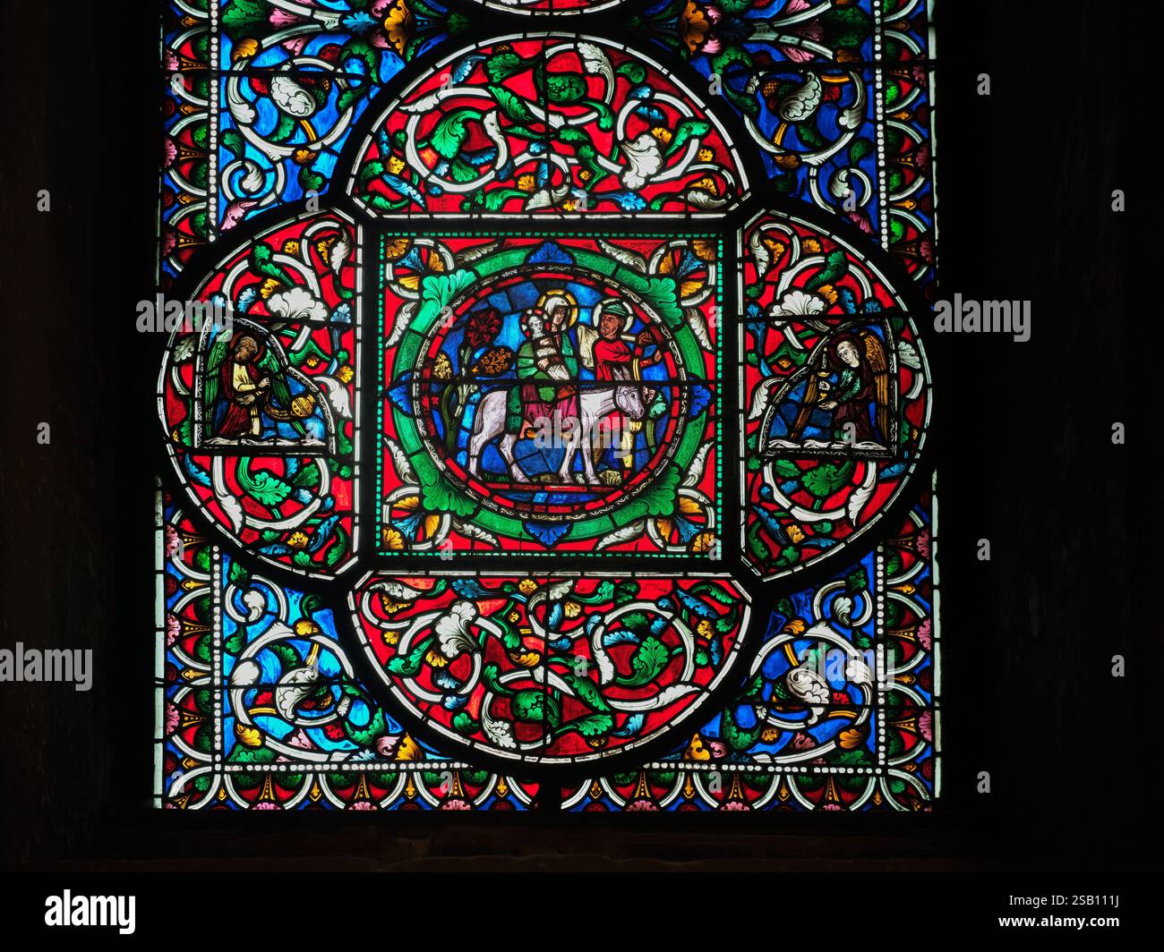 Medieval stained glass window, of Joseph and Mary fleeing to Egypt with ...