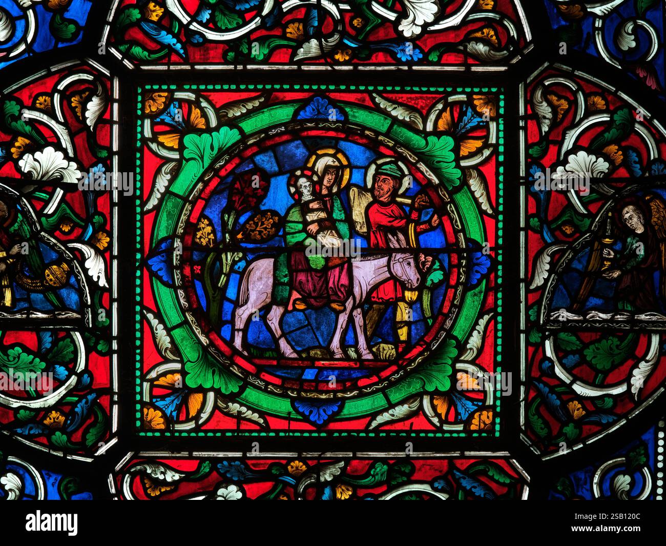 Medieval stained glass window, of Joseph and Mary fleeing to Egypt with ...