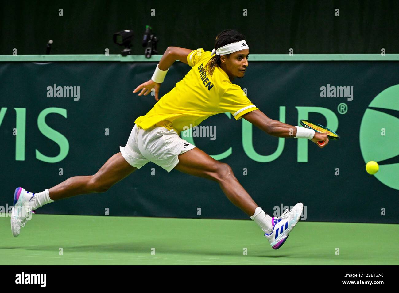 Sweden's Mikael Ymer returns the ball to Australia's Alex de Minaur ...