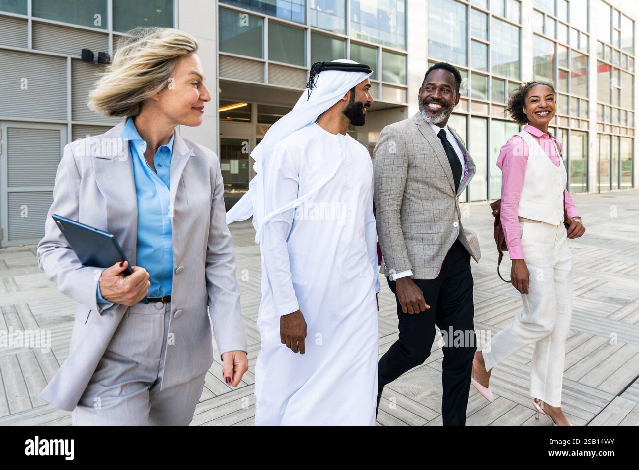 Group of multiethnic business people meeting an emirati businessman ...