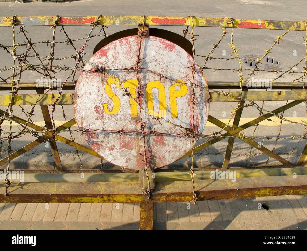 Rusty police barricade with barbed wire in Dhaka, Bangladesh, used for ...